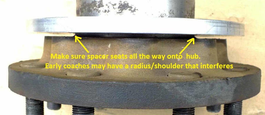 Place the hub so the inner bearing end is facing up. Slide a spacer ...